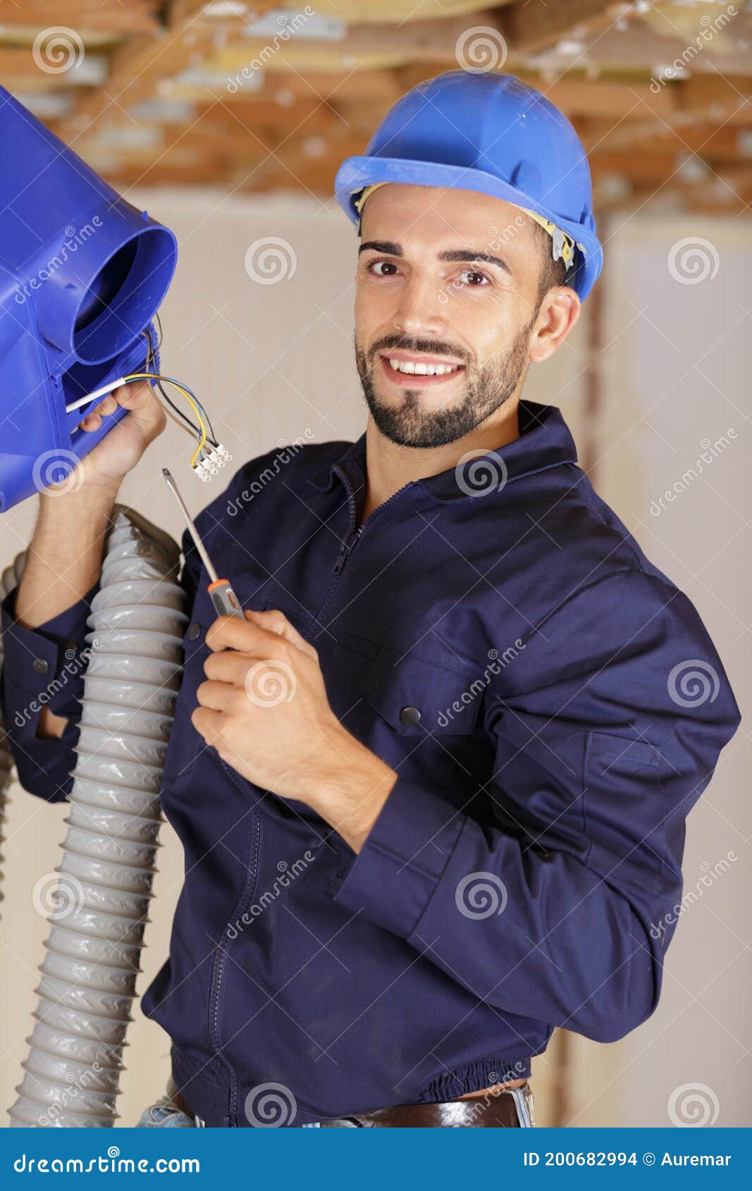 Happy Young Plumber Looking at Camera Stock Photo - Image of adjusting ...