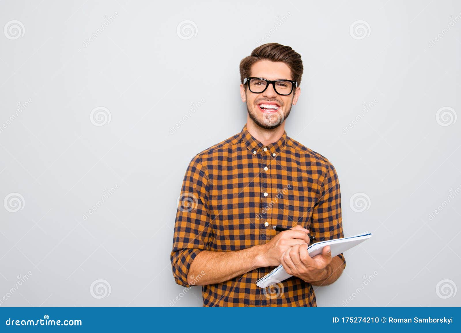Happy Young Smart Student in Glasses Writing in Notebook Stock Photo ...