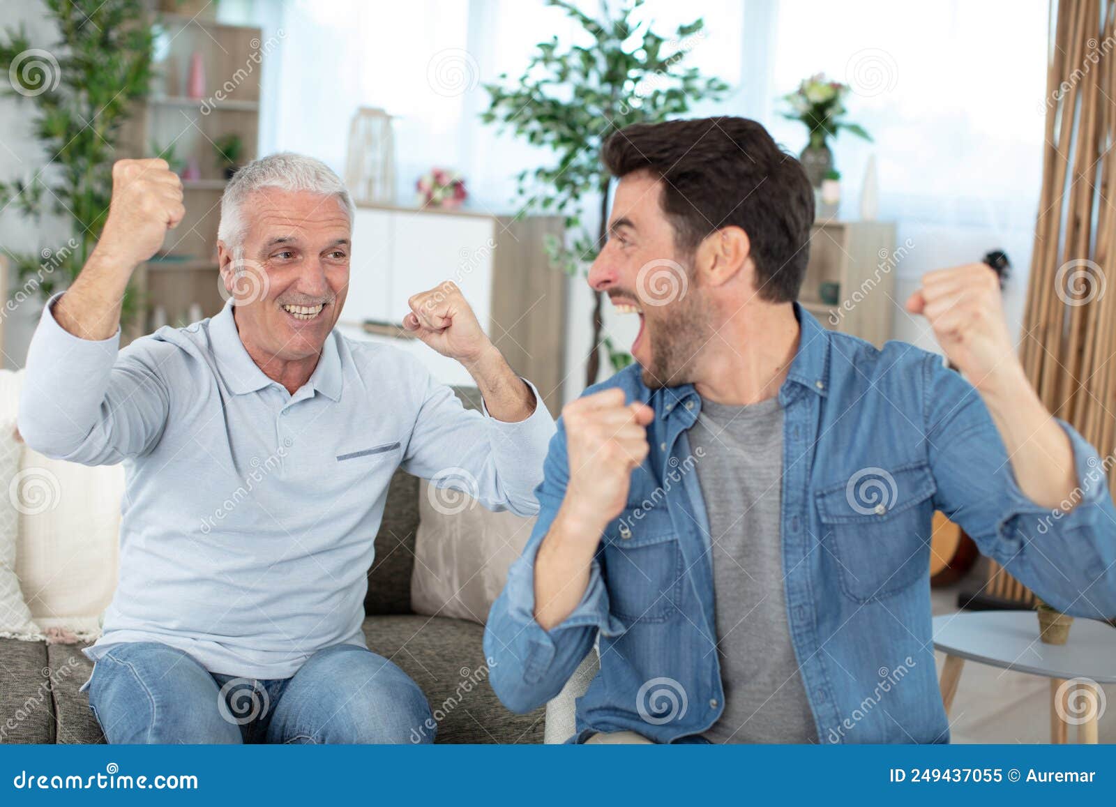 Happy Young Son and Old Father Celebrating Success Stock Image - Image ...