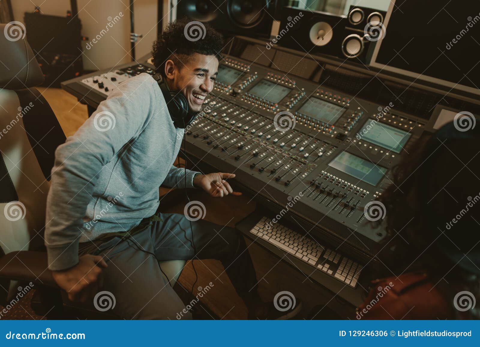 Happy Young Sound Producer Sitting Stock Photo - Image of male ...