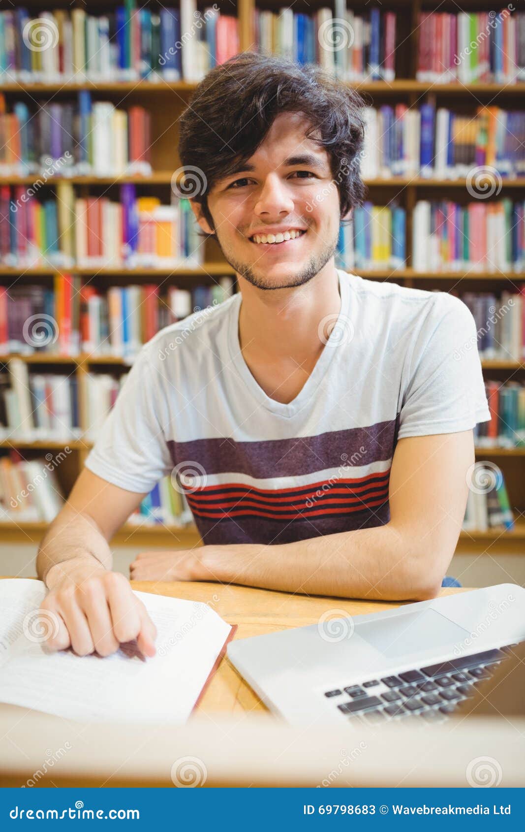 Happy Young Student Sitting at Desk Reading a Book Stock Image - Image ...