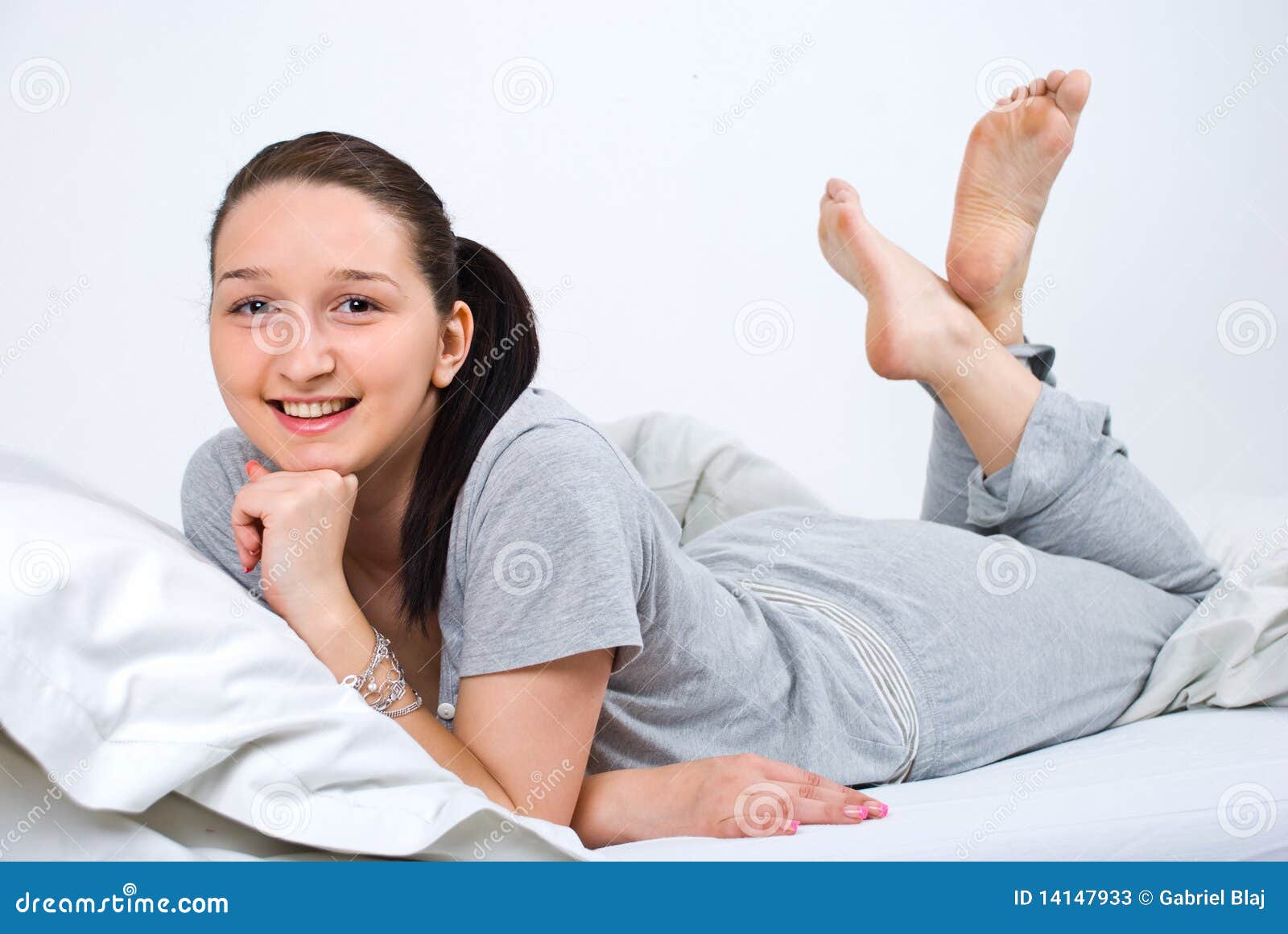 Happy young woman in bed stock image. Image of attractive - 14147933
