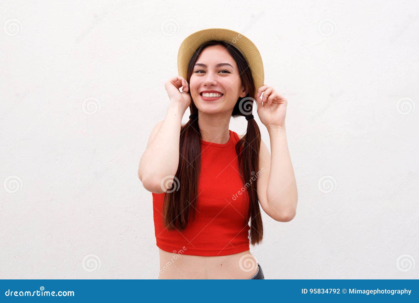 Happy Young Woman with Both Hands on Hat Stock Photo - Image of copy ...