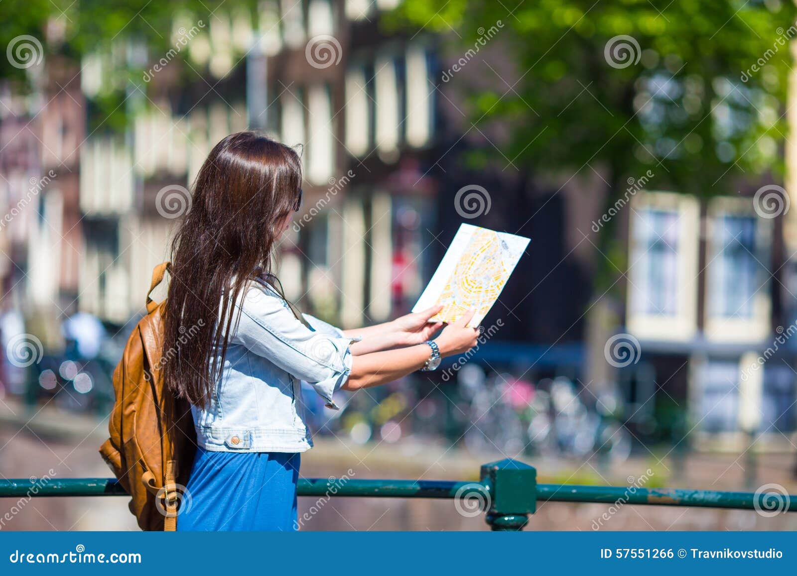 Happy Young Woman with a City Map and Backpack in Stock Photo - Image ...