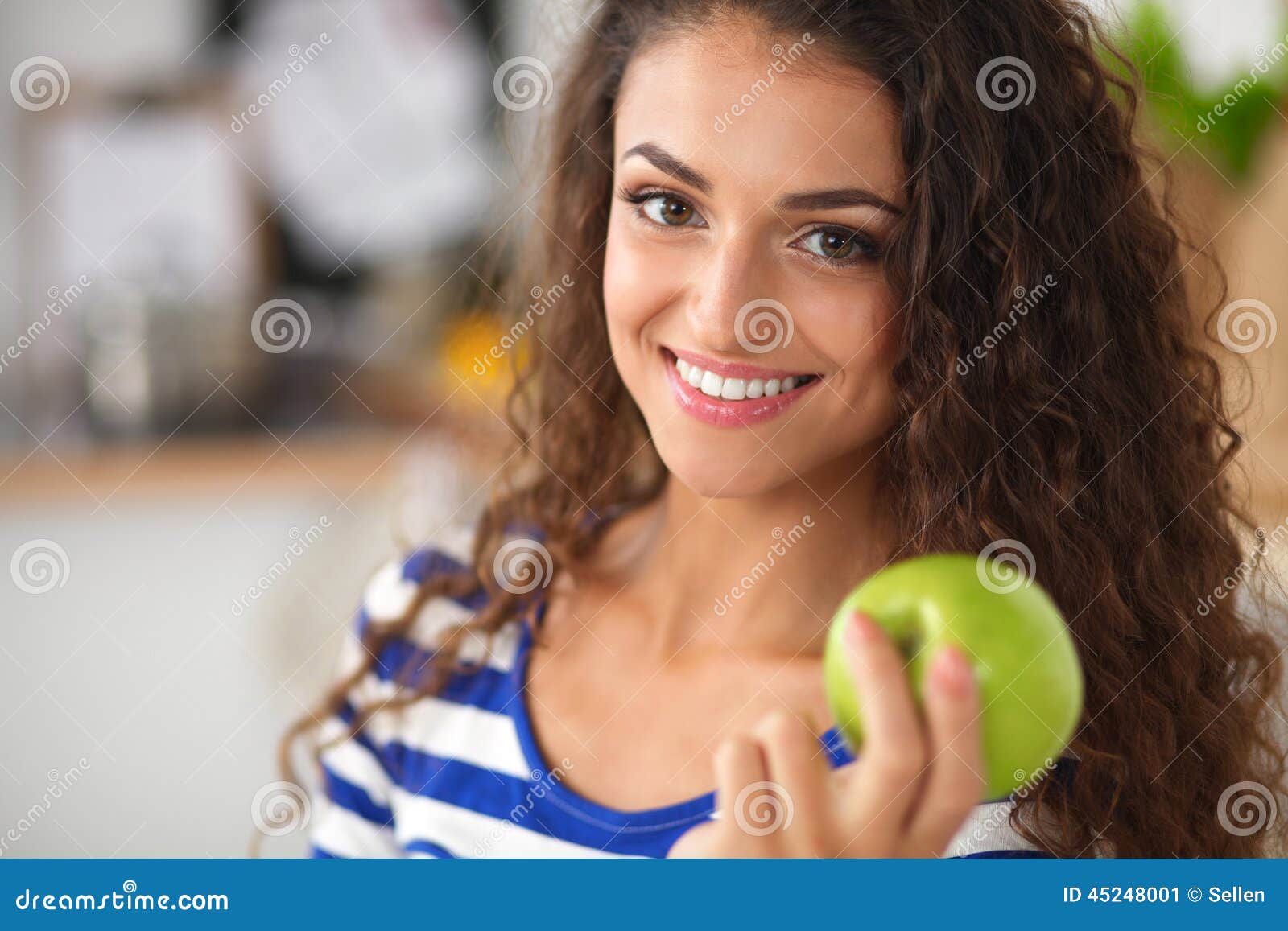 Happy Young Woman Eating Apples on Kitchen Stock Image - Image of ...