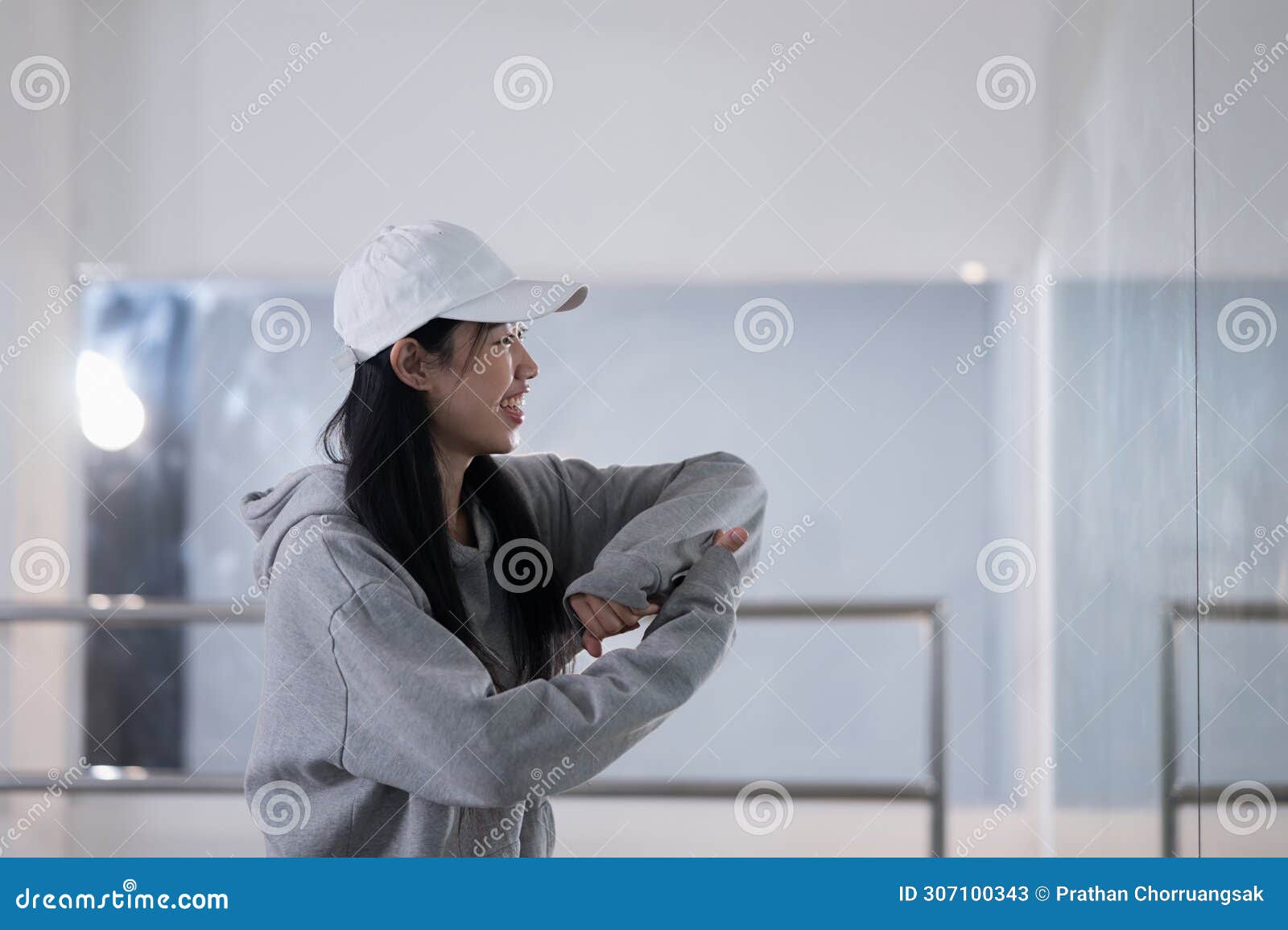 Happy Young Woman Looking at Her Reflection in the Mirror while ...