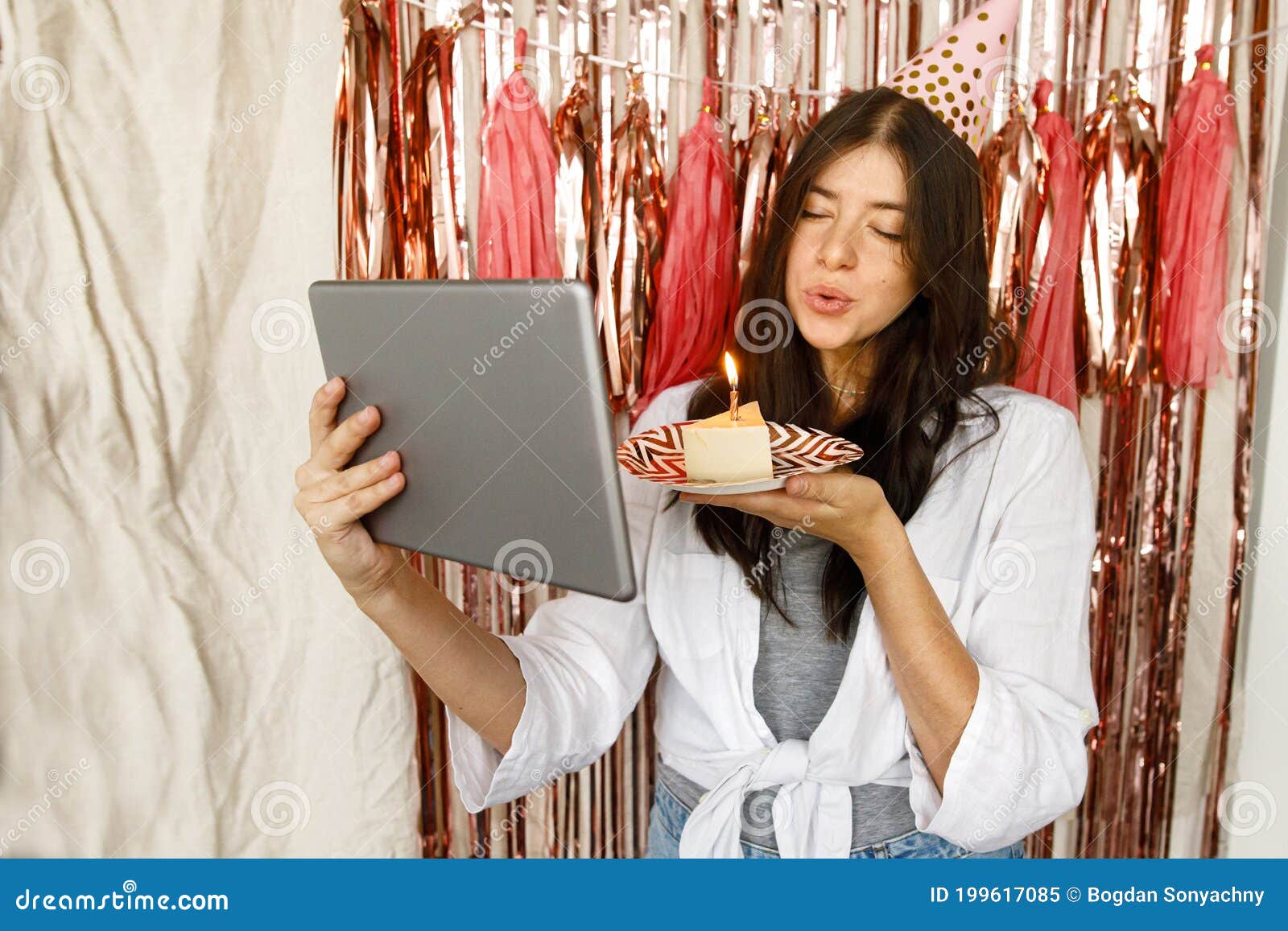 Happy Woman Making A Wish And Blowing Candle On Birthday Cake And