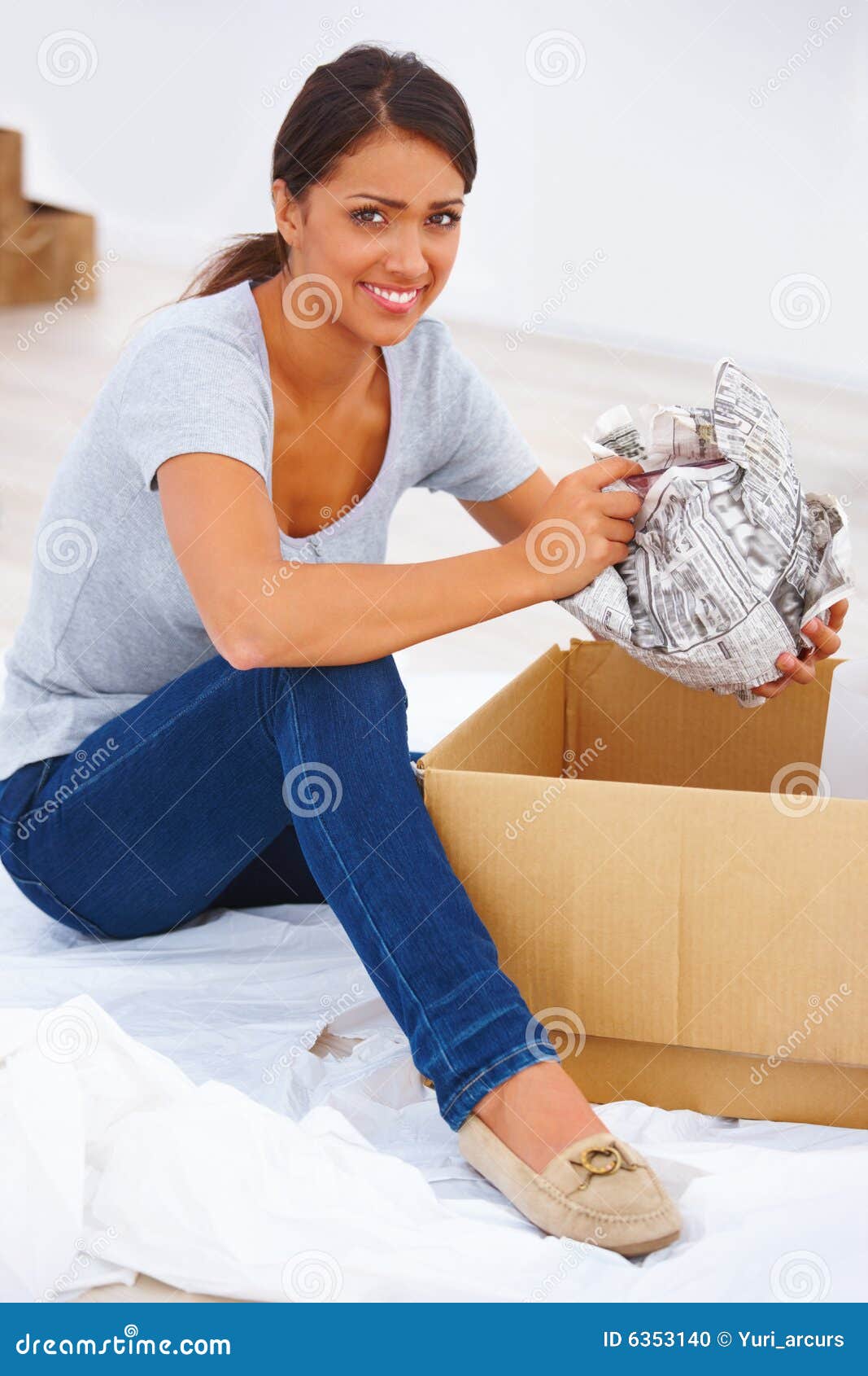 Happy Young Woman Packing a Box Stock Photo - Image of ladies, jeans ...