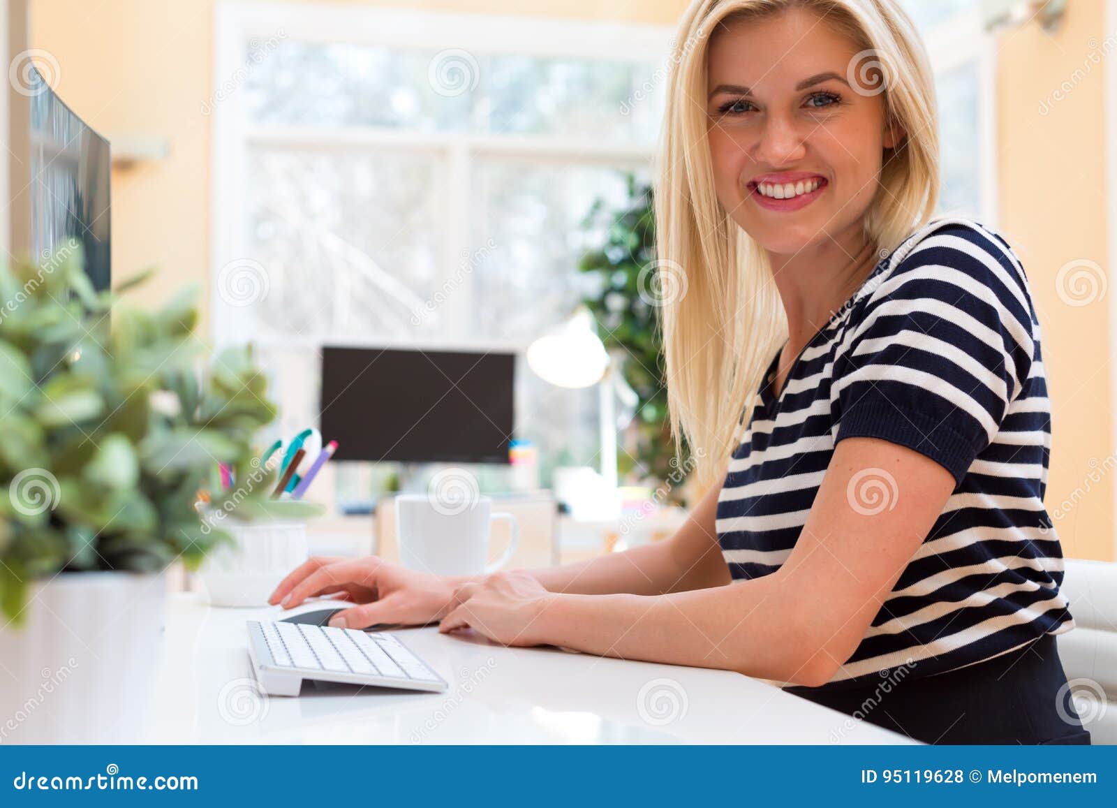 Happy Young Woman Sitting at Her Desk Stock Photo - Image of ...