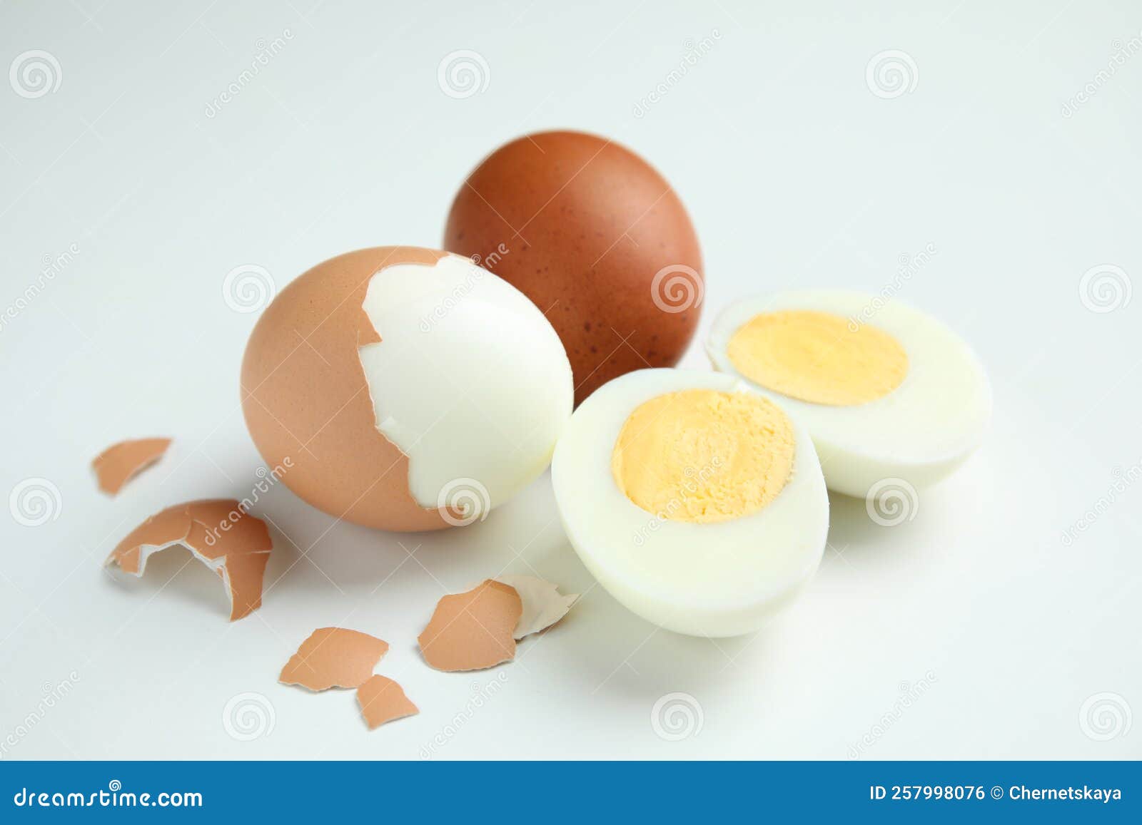 Hard Boiled Eggs and Pieces of Shell on White Background Stock Photo ...