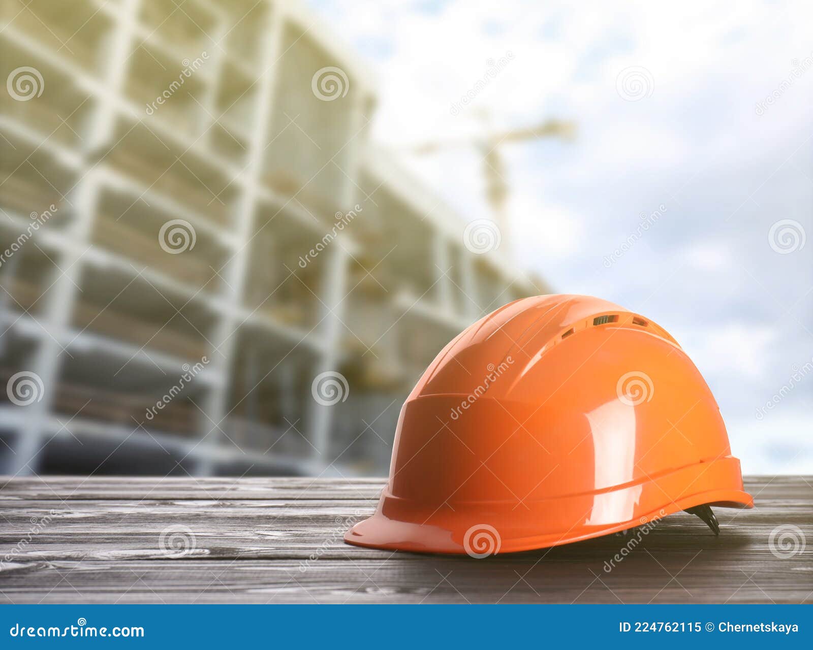 Hard Hat on Surface at Construction Site with Unfinished Building ...