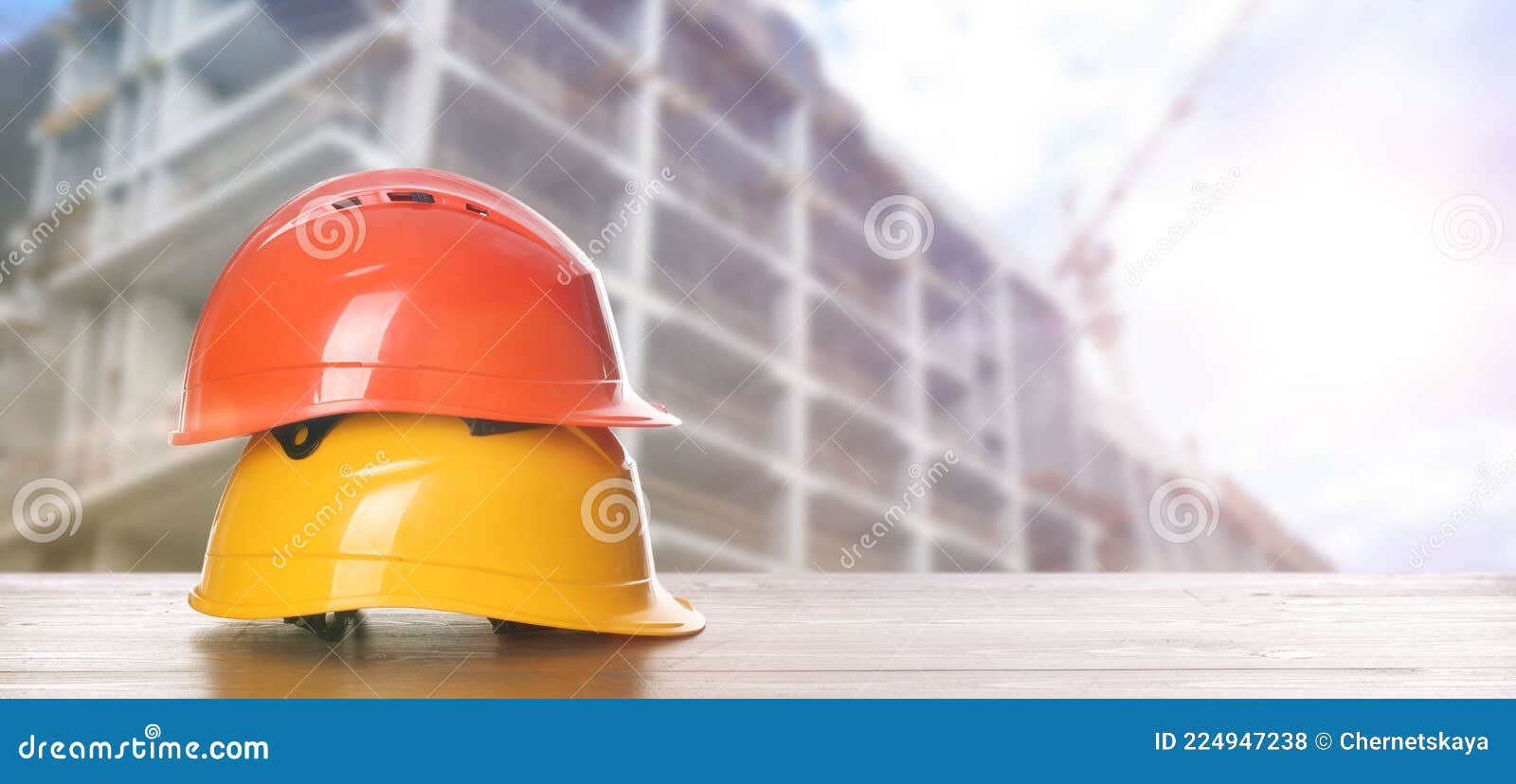 Hard Hats on Wooden Surface at Construction Site with Unfinished ...
