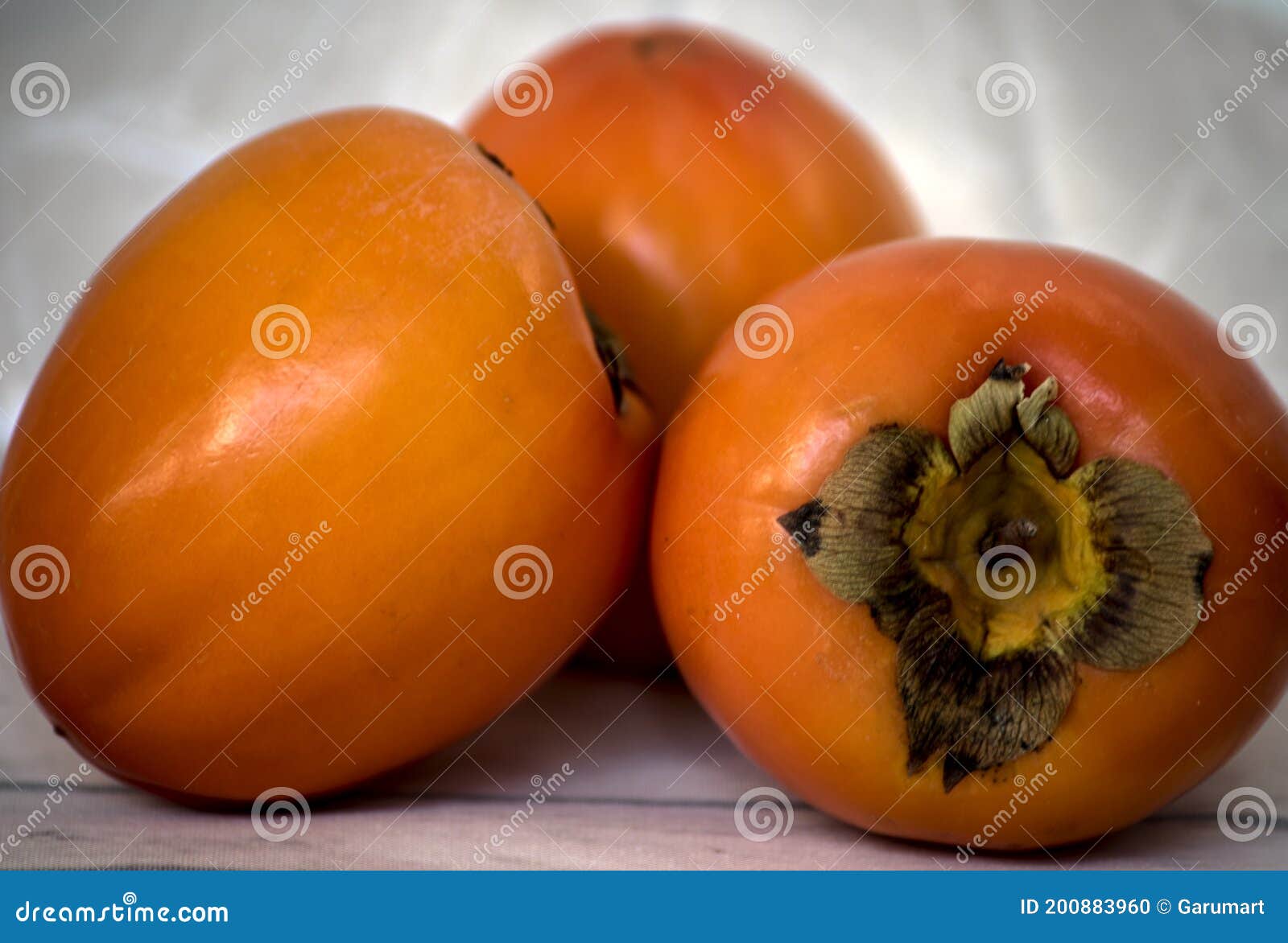 Hard Persimmons on Abstract White Background Stock Photo - Image of ...