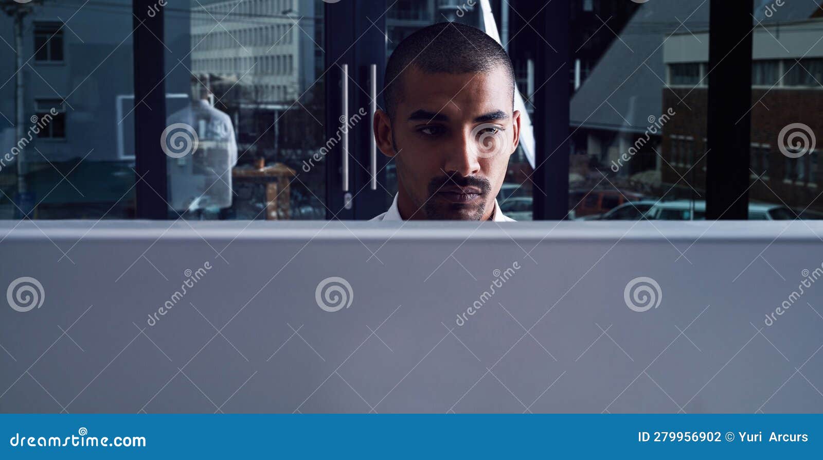 The Hard Work Behind Success. a Young Businessman Using a Computer at ...