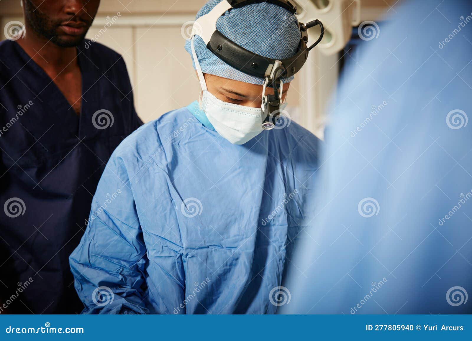 Hard at Work in the ER. a Team of Surgeons Performing a Surgery in an ...