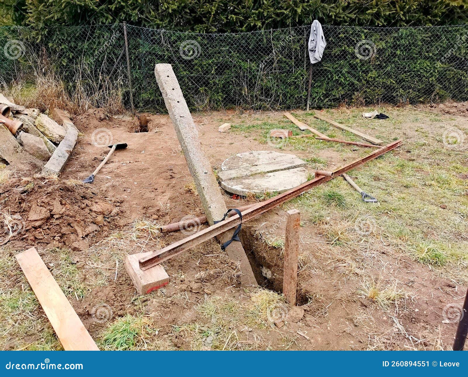 Hard Work in the Garden, Pulling a Concrete Column Out of the Ground ...