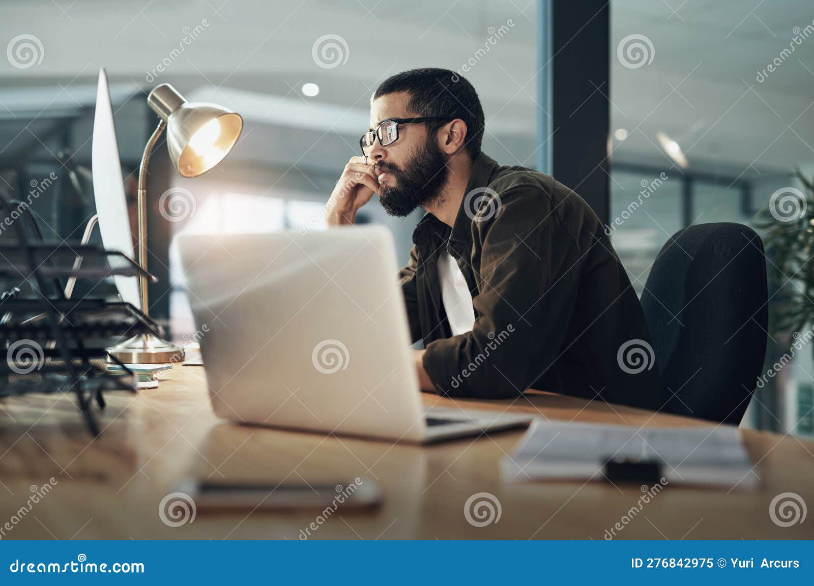 Hard Work Gets it All. a Young Businessman Using a Computer during a ...