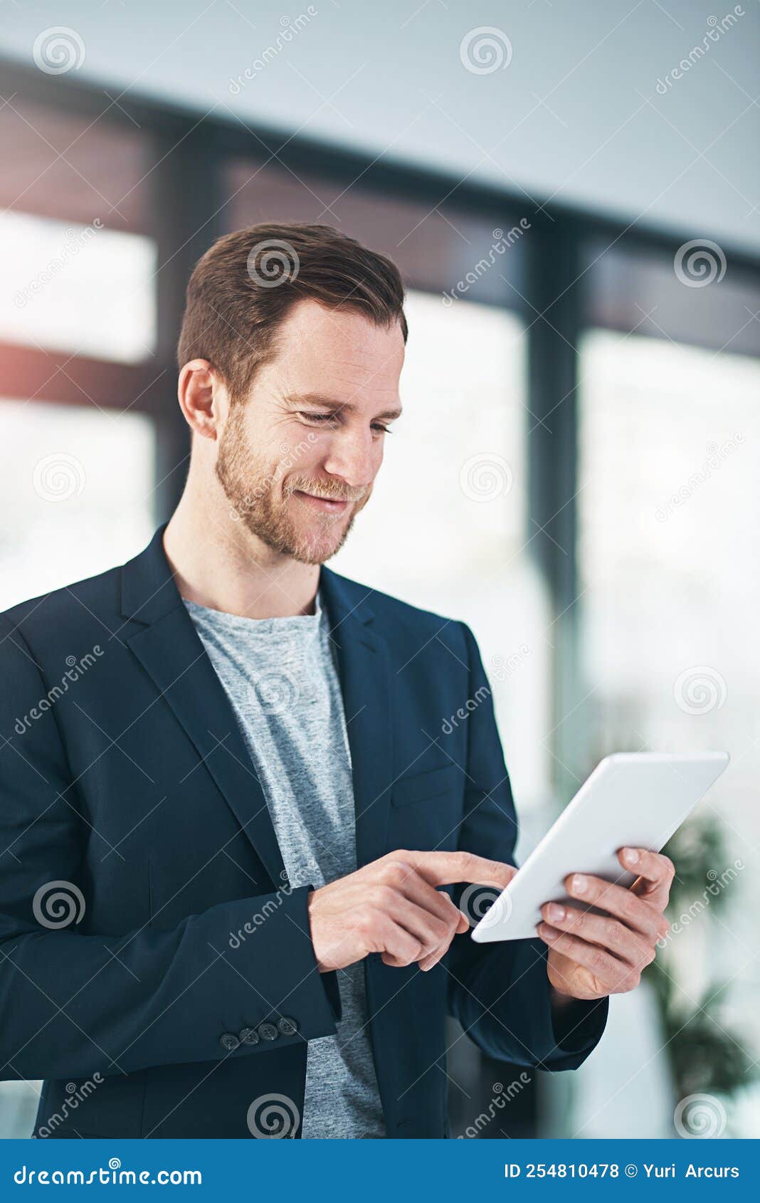 Hard Work Keeps Him on Top. a Successful Businessman Using His Tablet ...