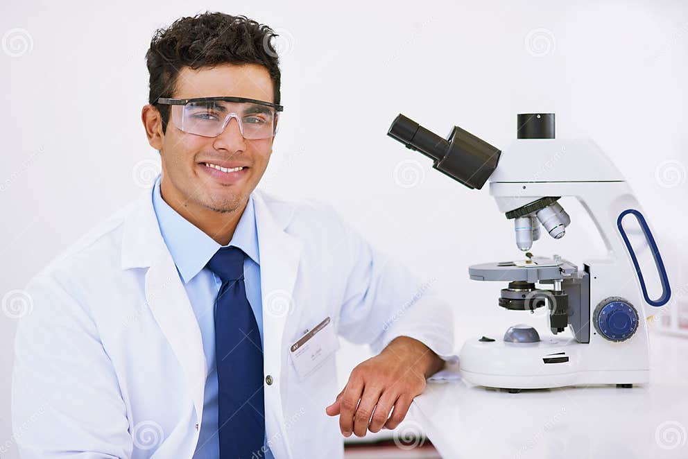 Hard at Work in the Lab. Portrait of a Smiling Lab Technician Using a ...