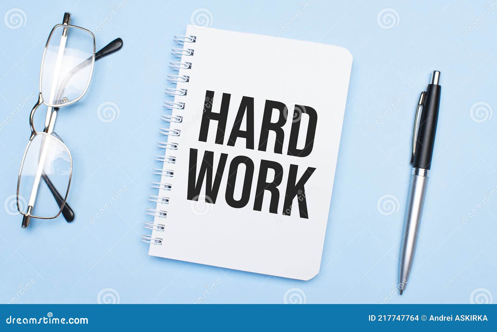 HARD WORK Words in White Notepad, Pen and Glasses on Blue Background ...