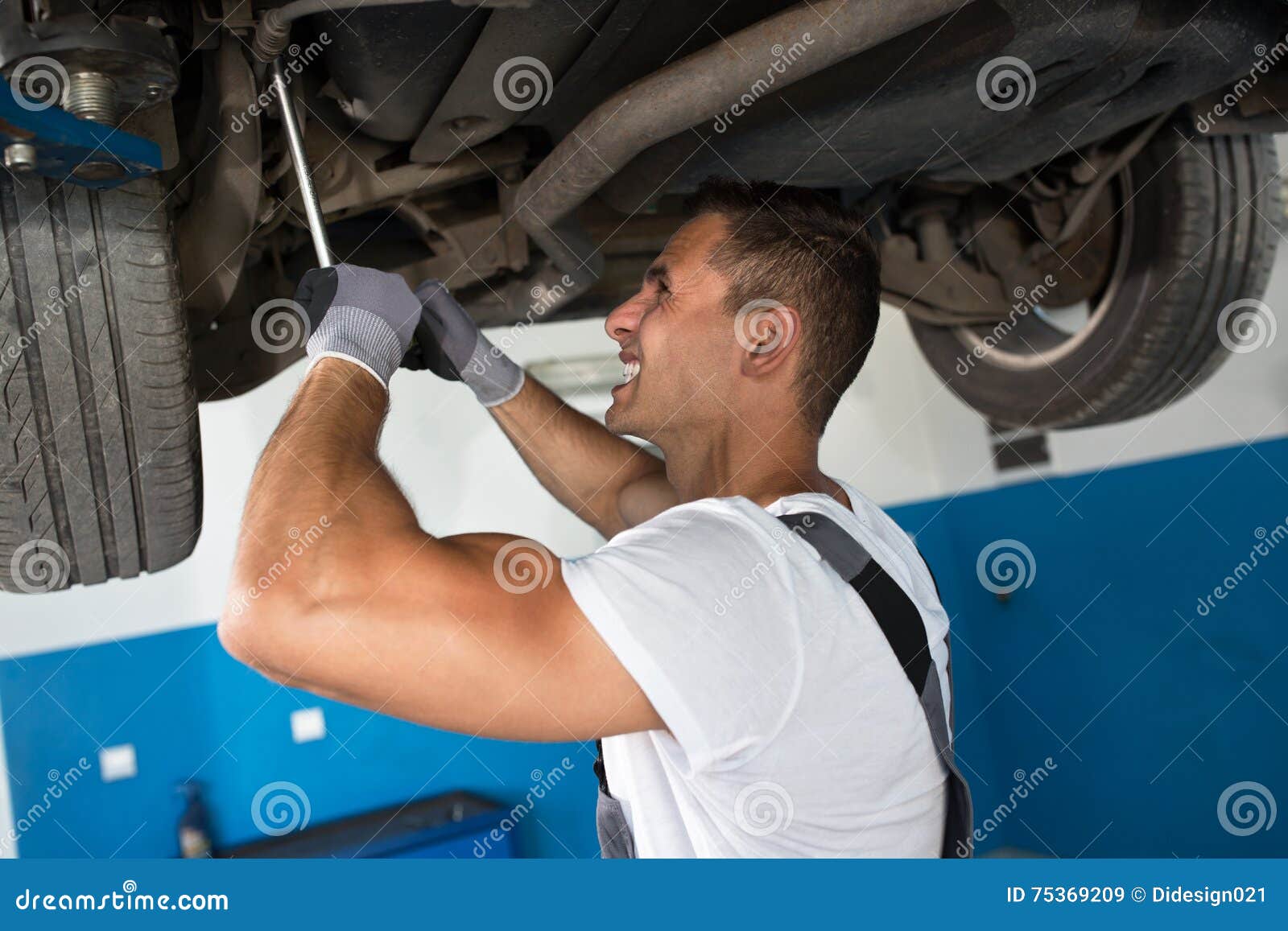 Hard worker under the car stock image. Image of happy - 75369209