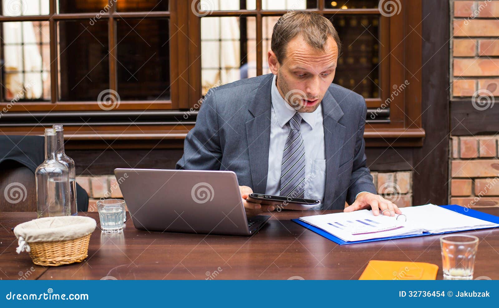 Hard Working Businessman in Restaurant with Laptop and Pad. Stock Photo ...