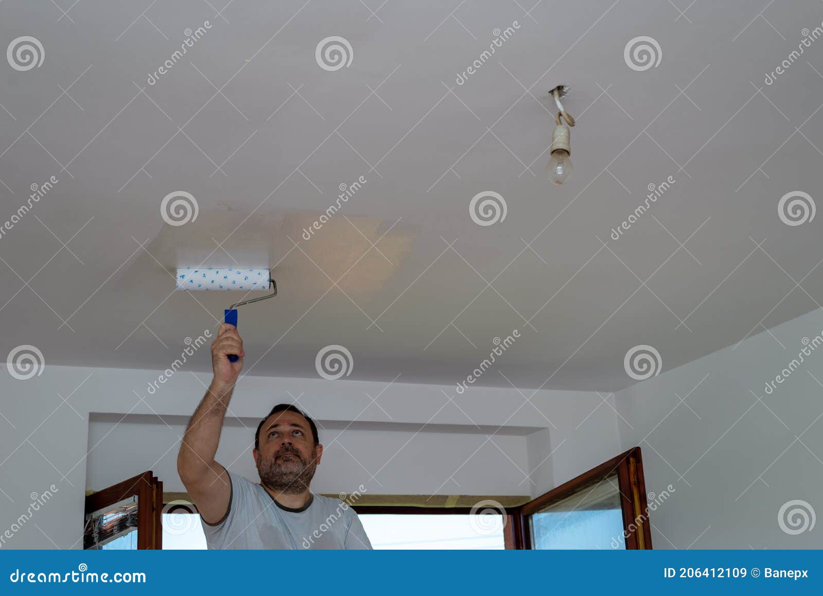 Man painting a ceiling stock image. Image of painter - 206412109