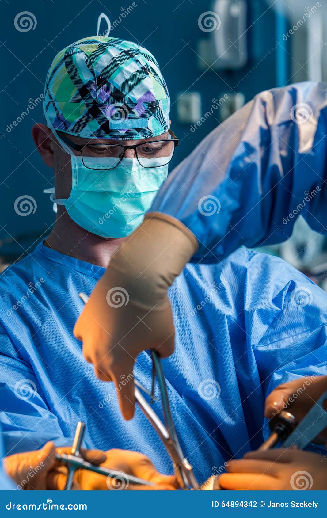Orthopedic Surgeons Performing A Wrist Arthroscopy On A Male Patient ...