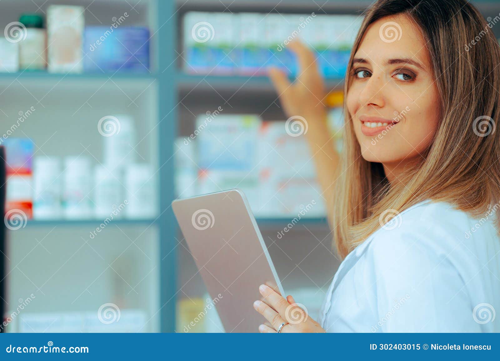 Pharmacist Holding a Pc Tablet Picking Something from a Shelf Stock ...