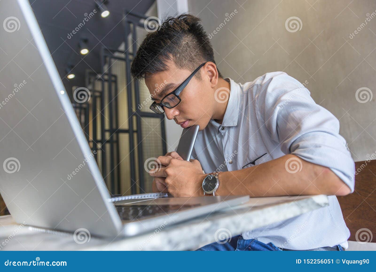 Hard-working Young Man Using Laptop Cellphone and Concentrating Stock ...