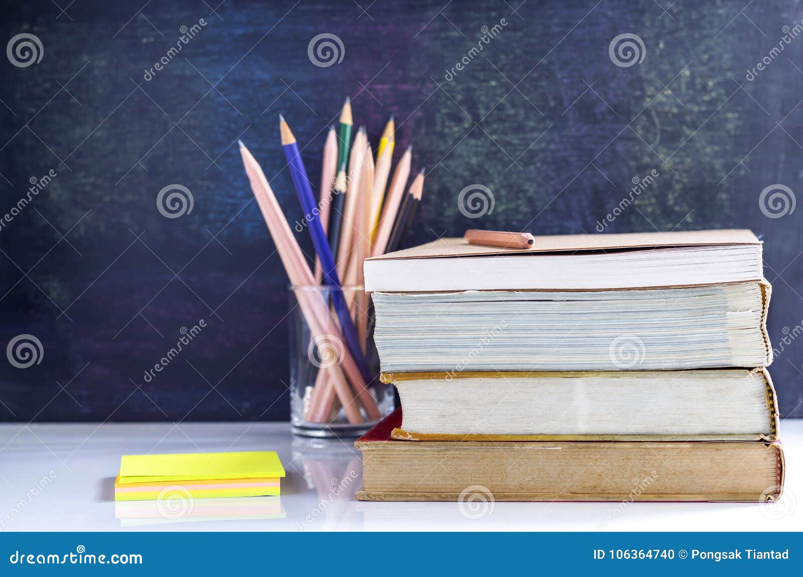 Hardback and Textbook Stacked with Pencils on the Table on the B Stock ...
