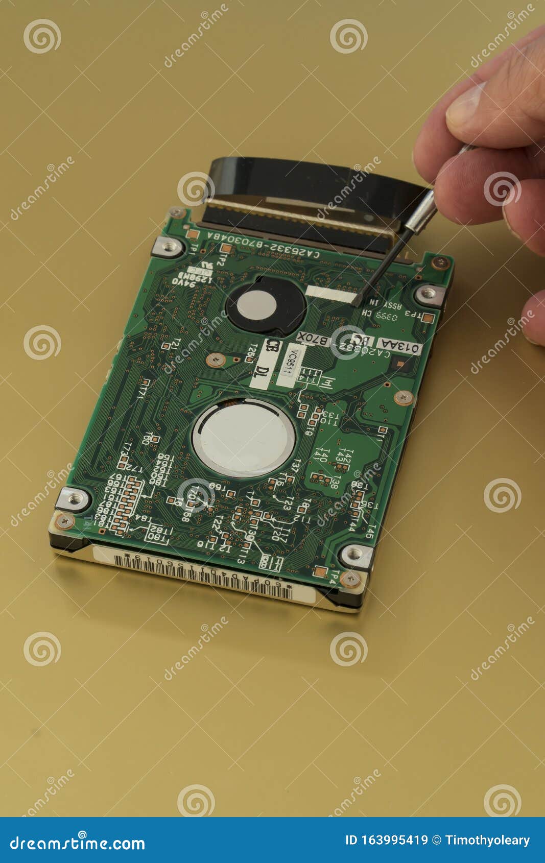 Harddrive from a Laptop Computer is Being Inspected by a Technician ...