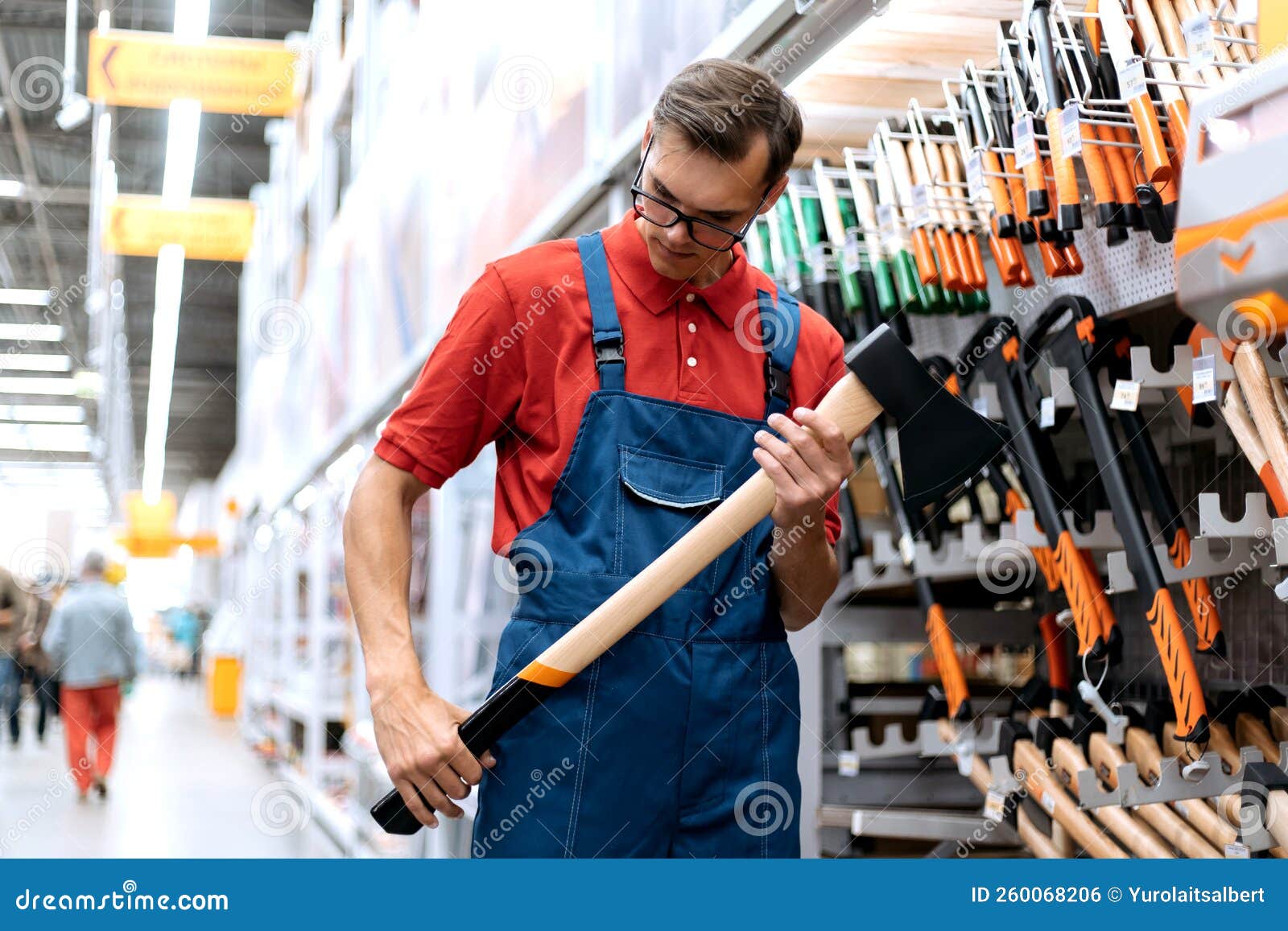 Hardware Store Clerk Looking at the Markings on the Axe. Stock Photo ...