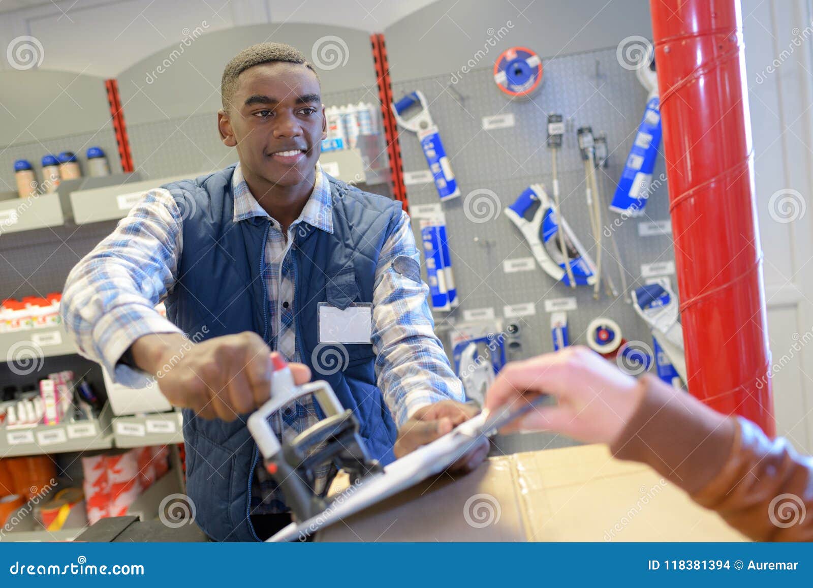 Hardware Store Employee Applying Stamp on Document Stock Photo - Image ...