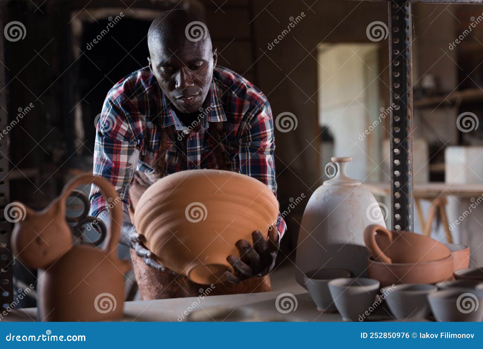 Potter Looking at Clay Dishware Stock Photo - Image of african, talent ...