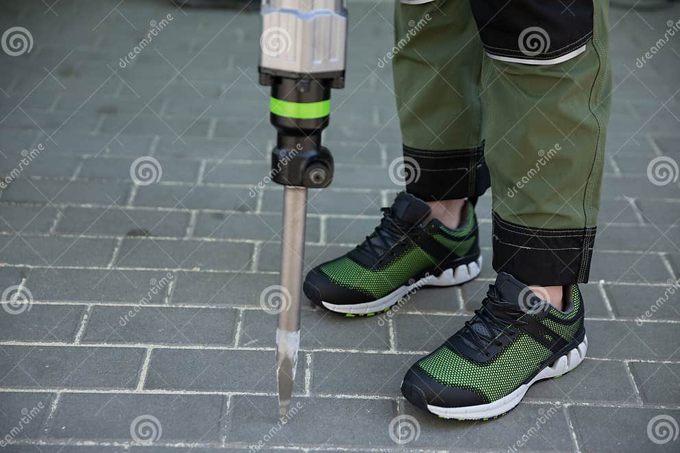 A Hardworking Construction Worker Equipped with a Demolition Tool ...