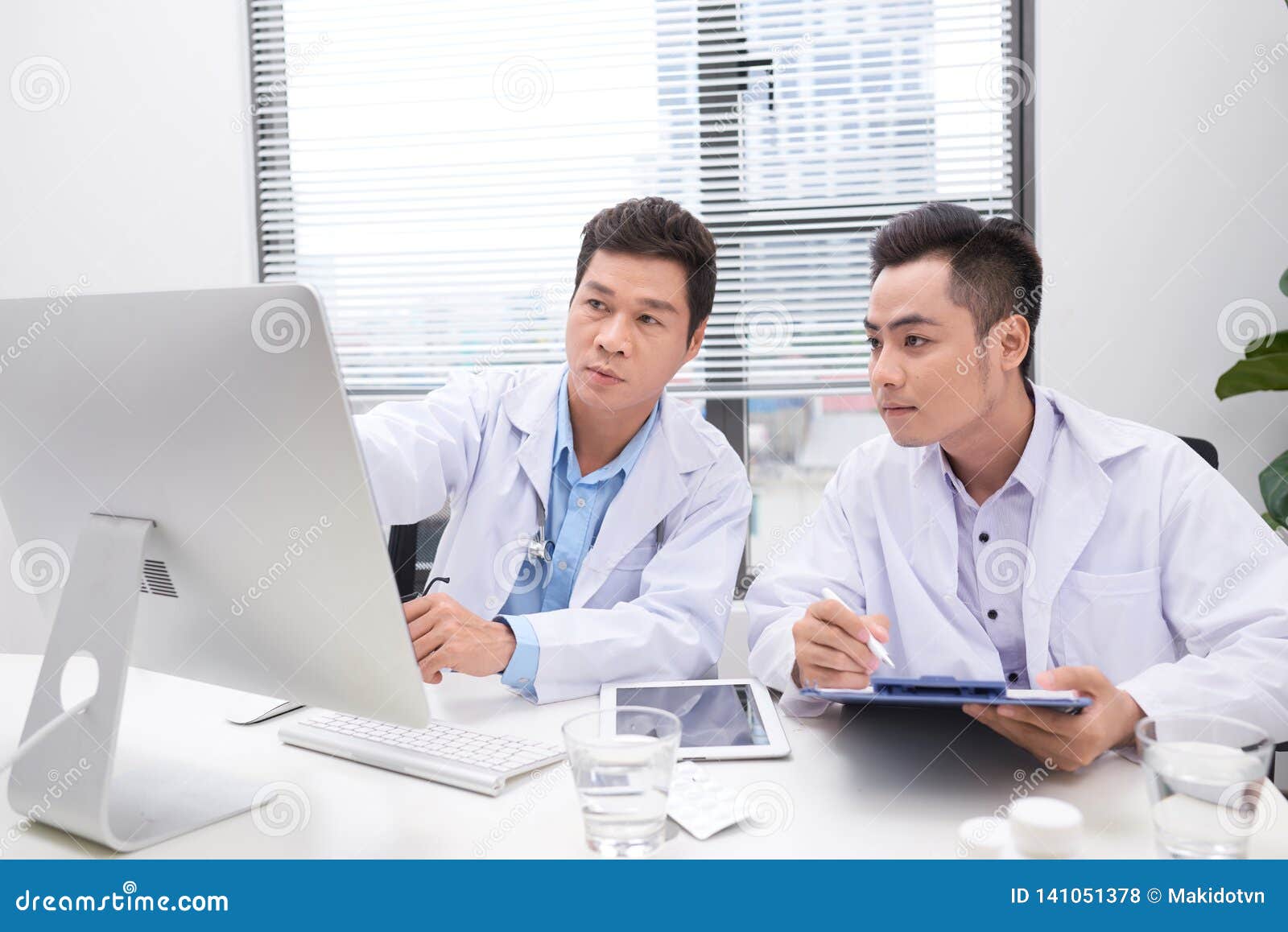 Hardworking Doctors Reviewing Patient`s File Stock Photo - Image of ...