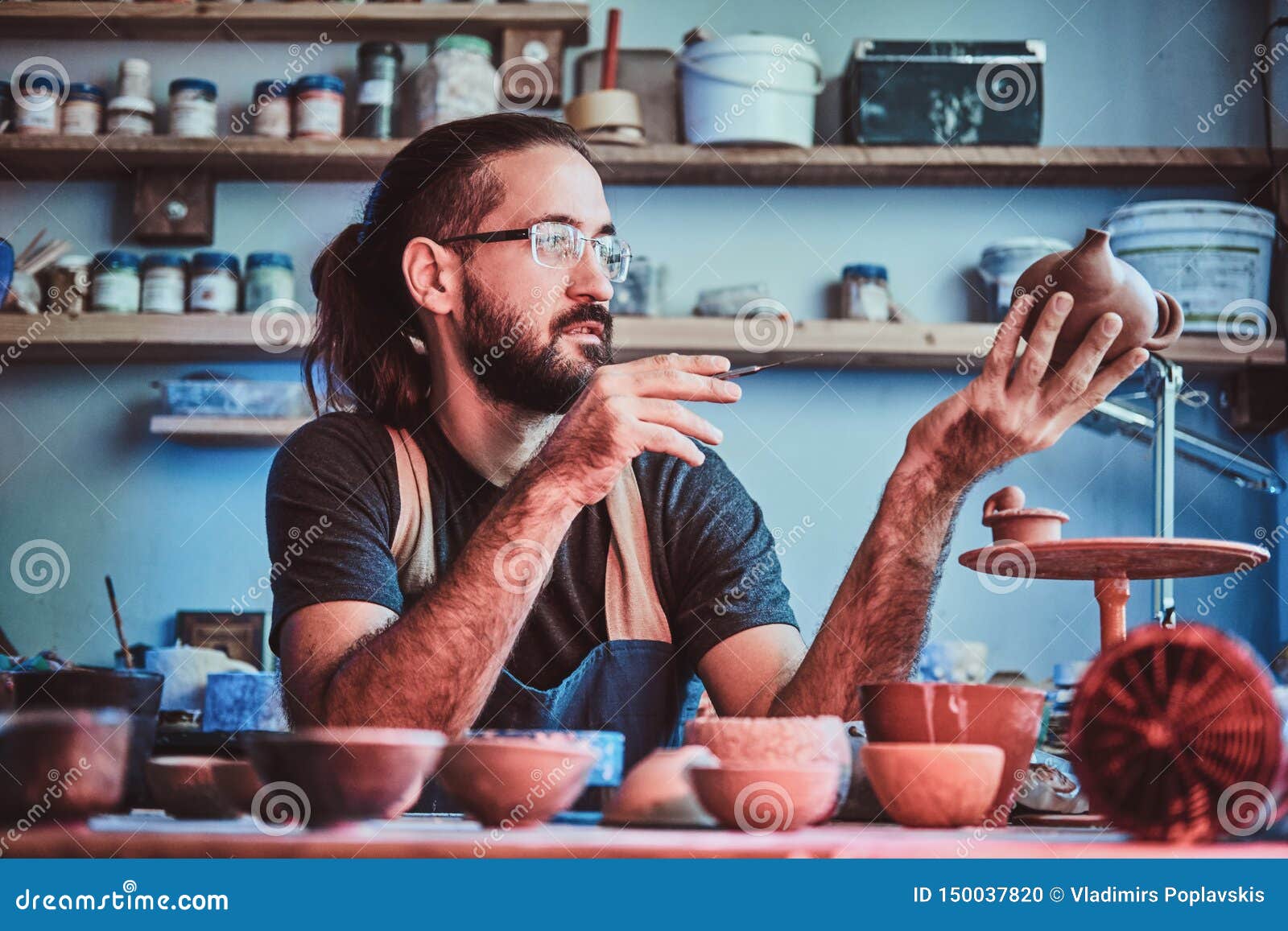 Hardworking Man is Looking at His Own Work, Ceramic Teapot. Stock Photo ...