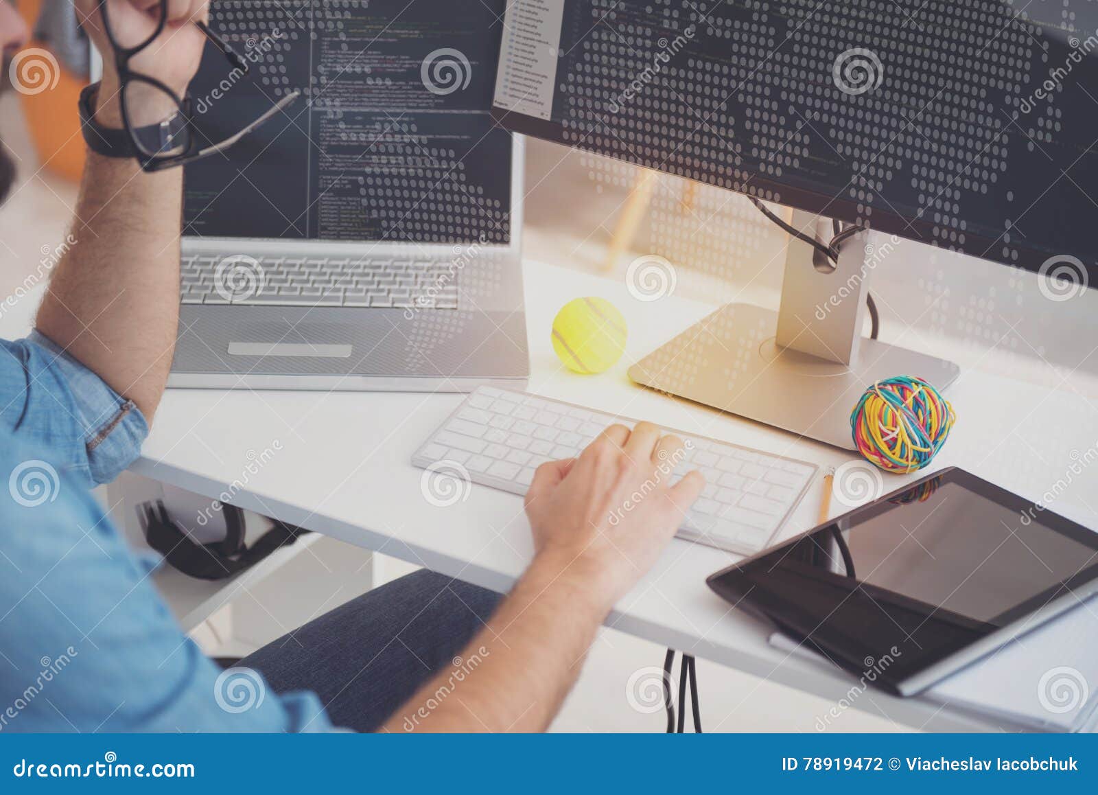 Hardworking Man Using Laptop and Computer in an Office Stock Photo ...