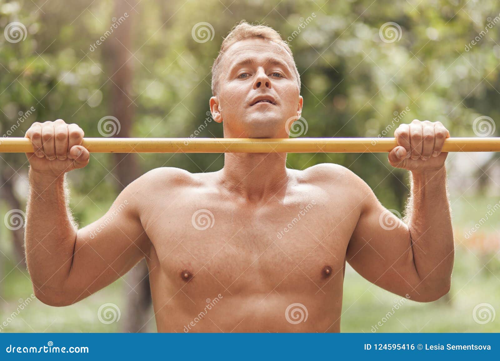 Hardy Robust Athletic Man with Bare Body, Does Pull Ups, Works on His ...