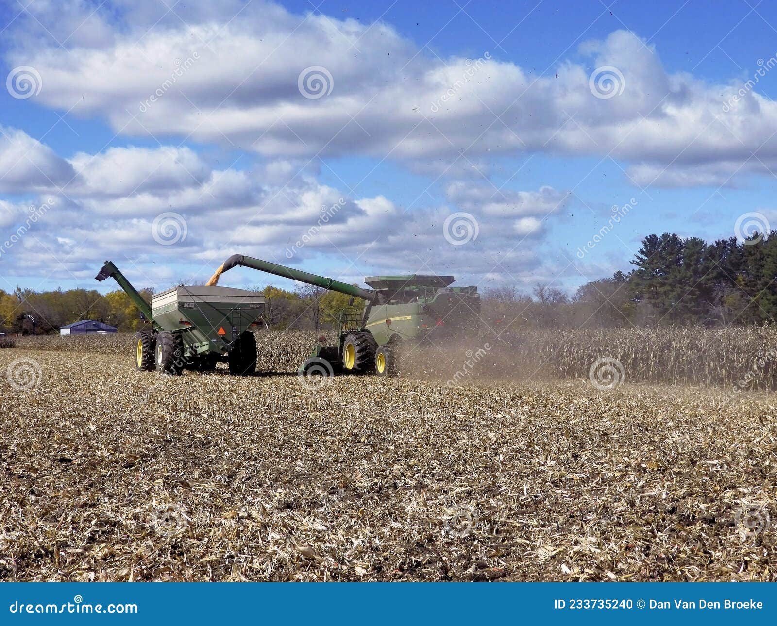 John Deere Combine Harvesting Corn And Unloading Into Killbros 1950 ...