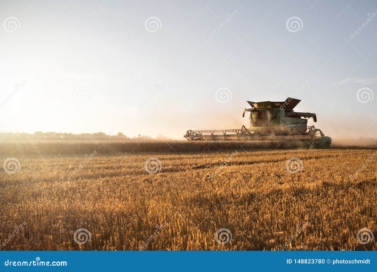 Wheat Field with a Combine Harvester at Sunset Stock Photo - Image of ...