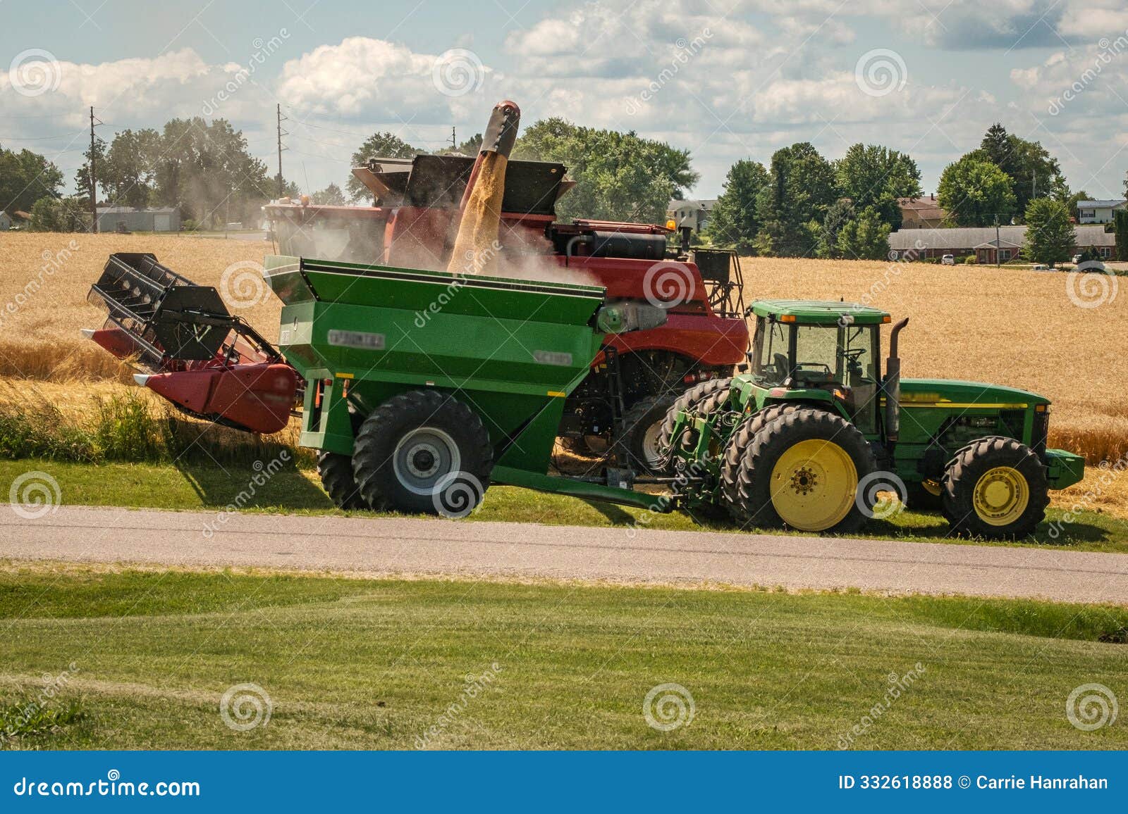 Harvester Combine Dumping Corn Into Grain Cart On Back Of Tractor In ...