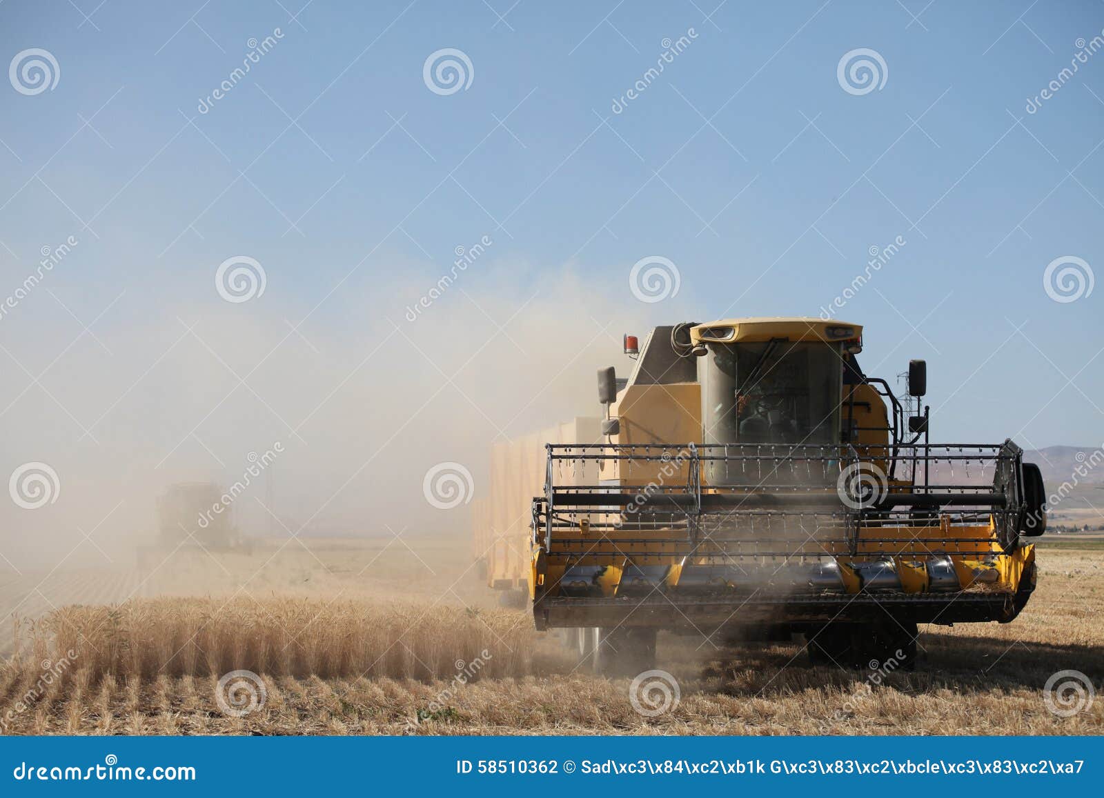 Harvesting Combine in the Wheat Stock Photo - Image of machine, working ...