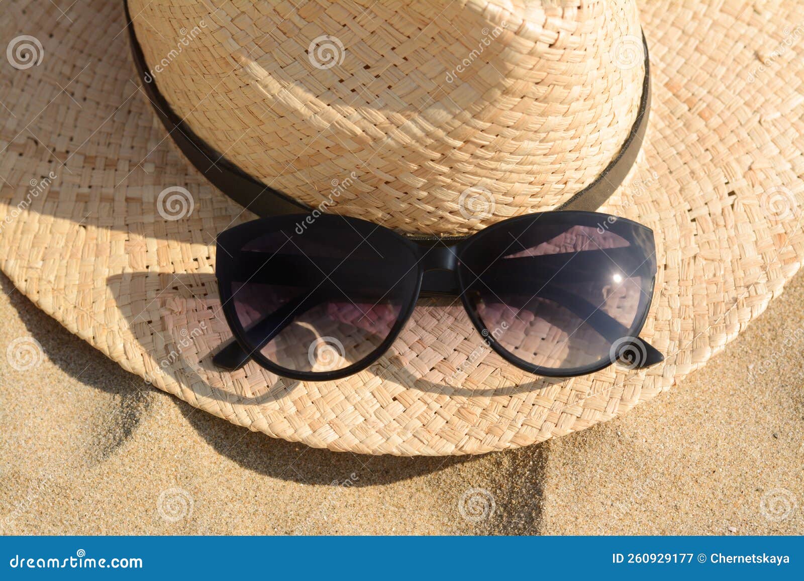 Hat with Beautiful Sunglasses on Sand, Closeup Stock Image - Image of ...