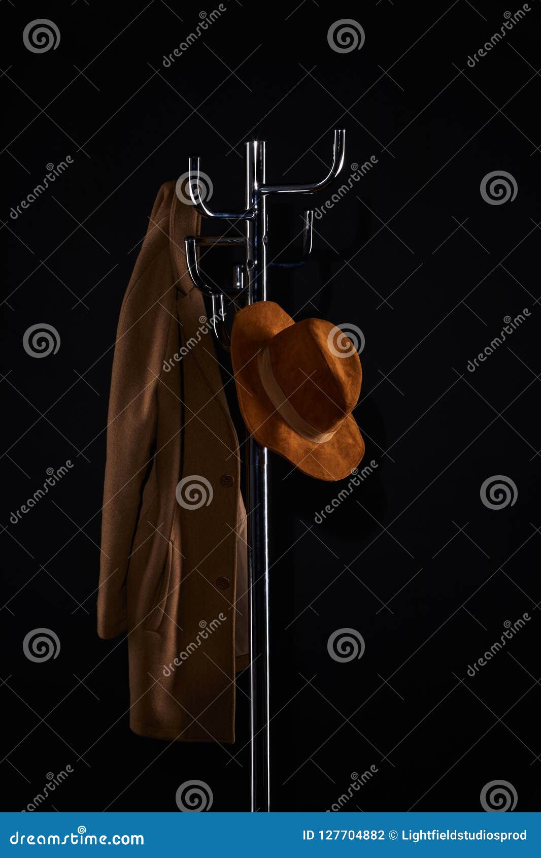 Hat and Coat Hanging on Coat Rack on Black Stock Photo - Image of ...