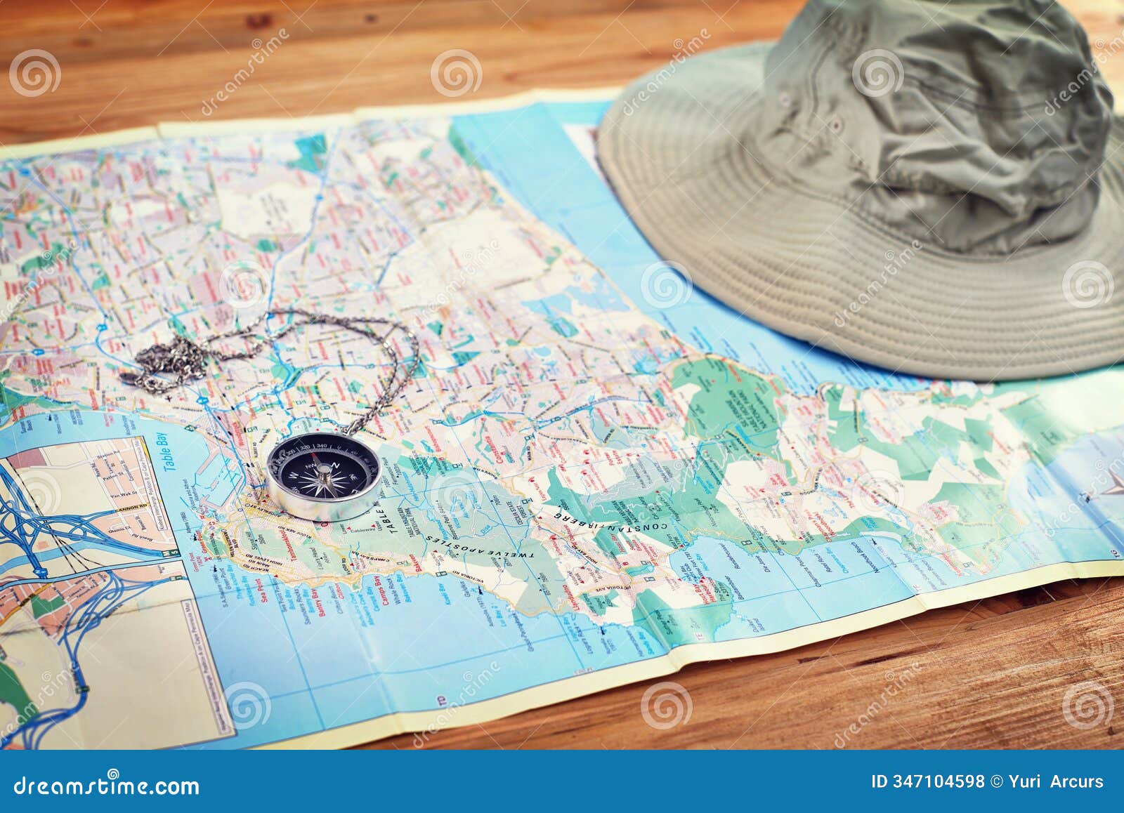 Hat, Map and Travel Guide with Compass on Table for Itinerary Schedule ...