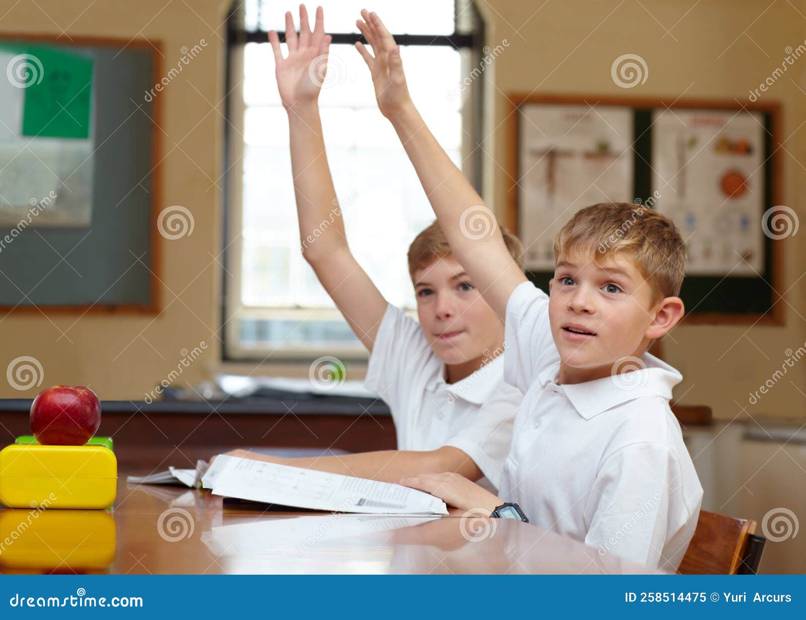 We Have the Answer. Two Young Schoolboys Raising Their Hands in a ...