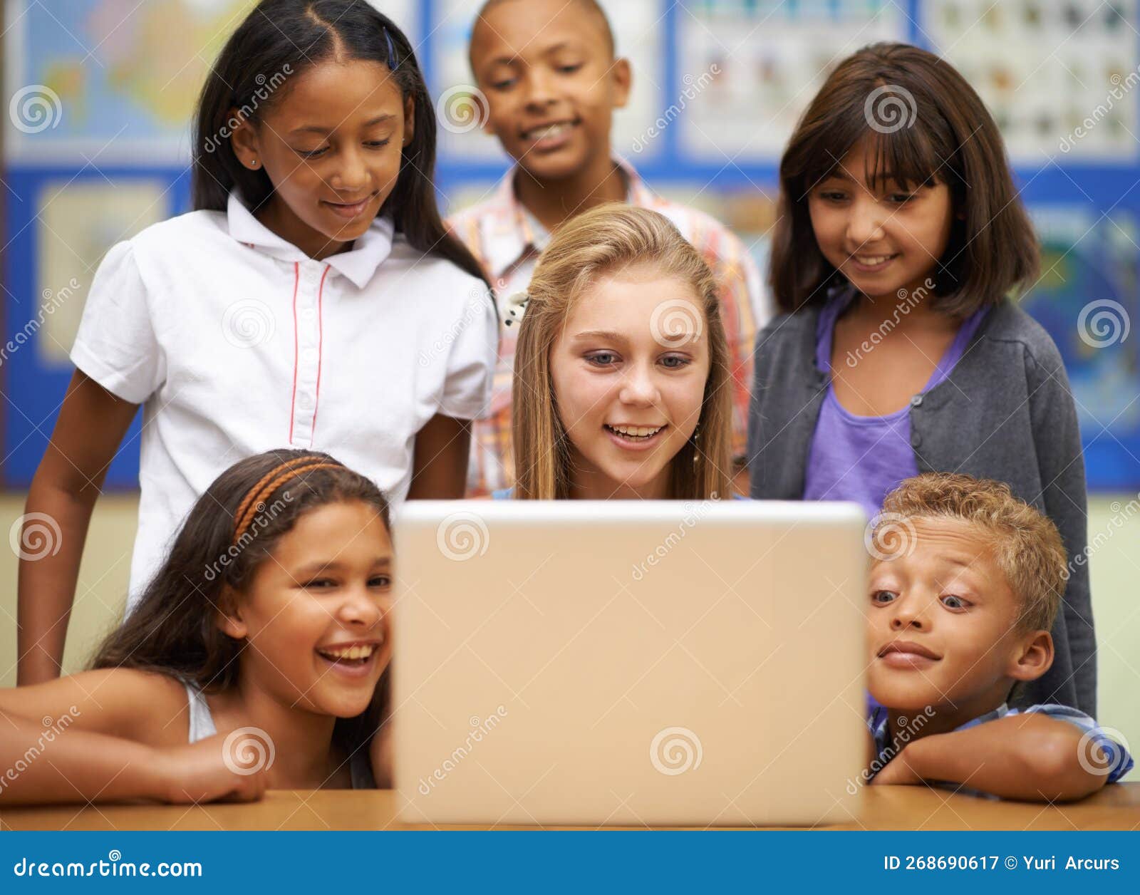 Having Fun during Computer Class. a Group of Pupils Working on a Laptop ...