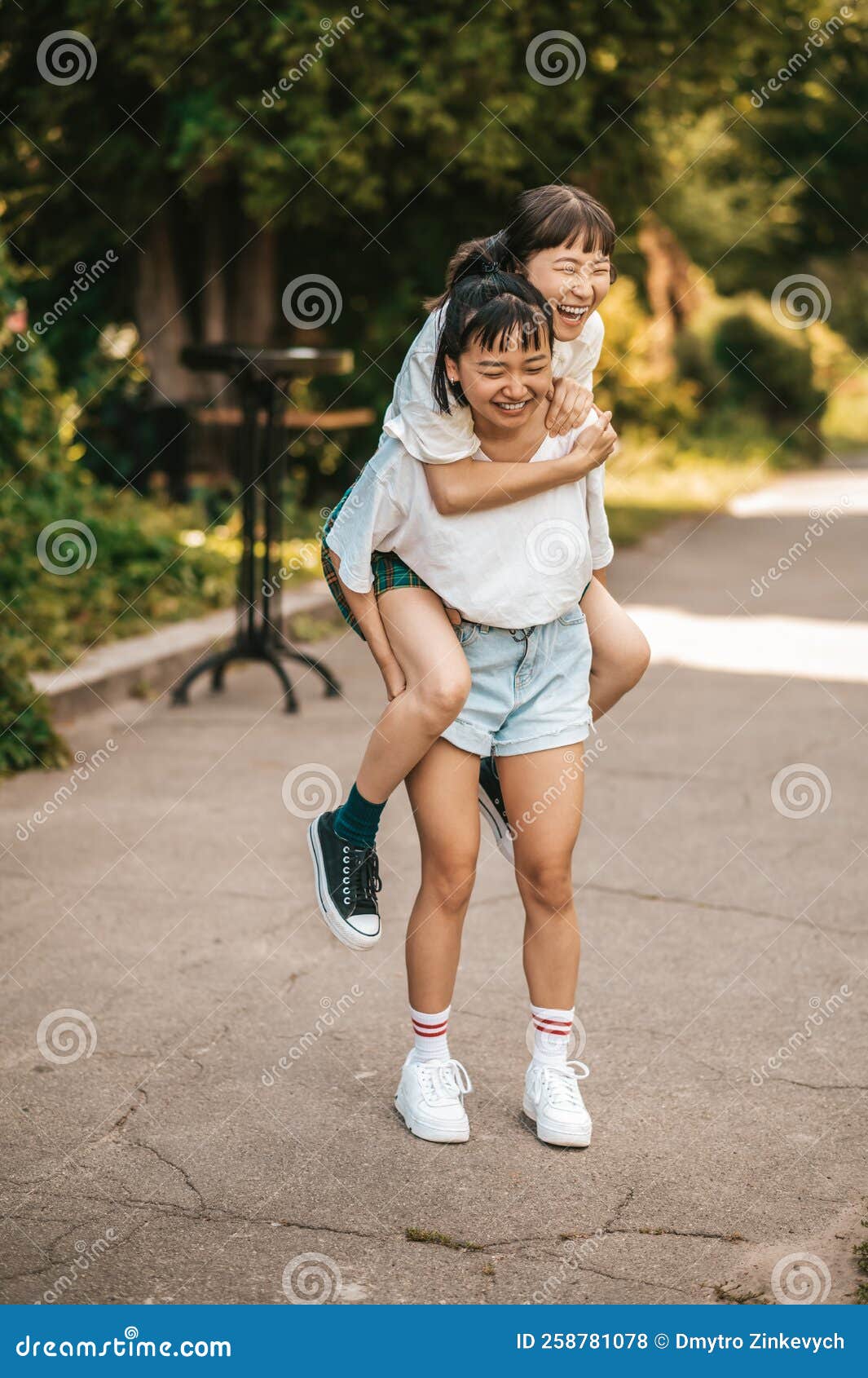 Two Girls Having Fun in the Park and Looking Excited Stock Photo ...